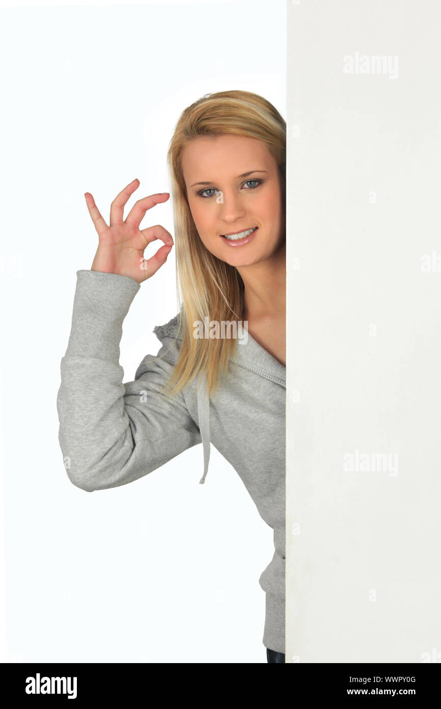 Young woman giving the okay sign Stock Photo - Alamy