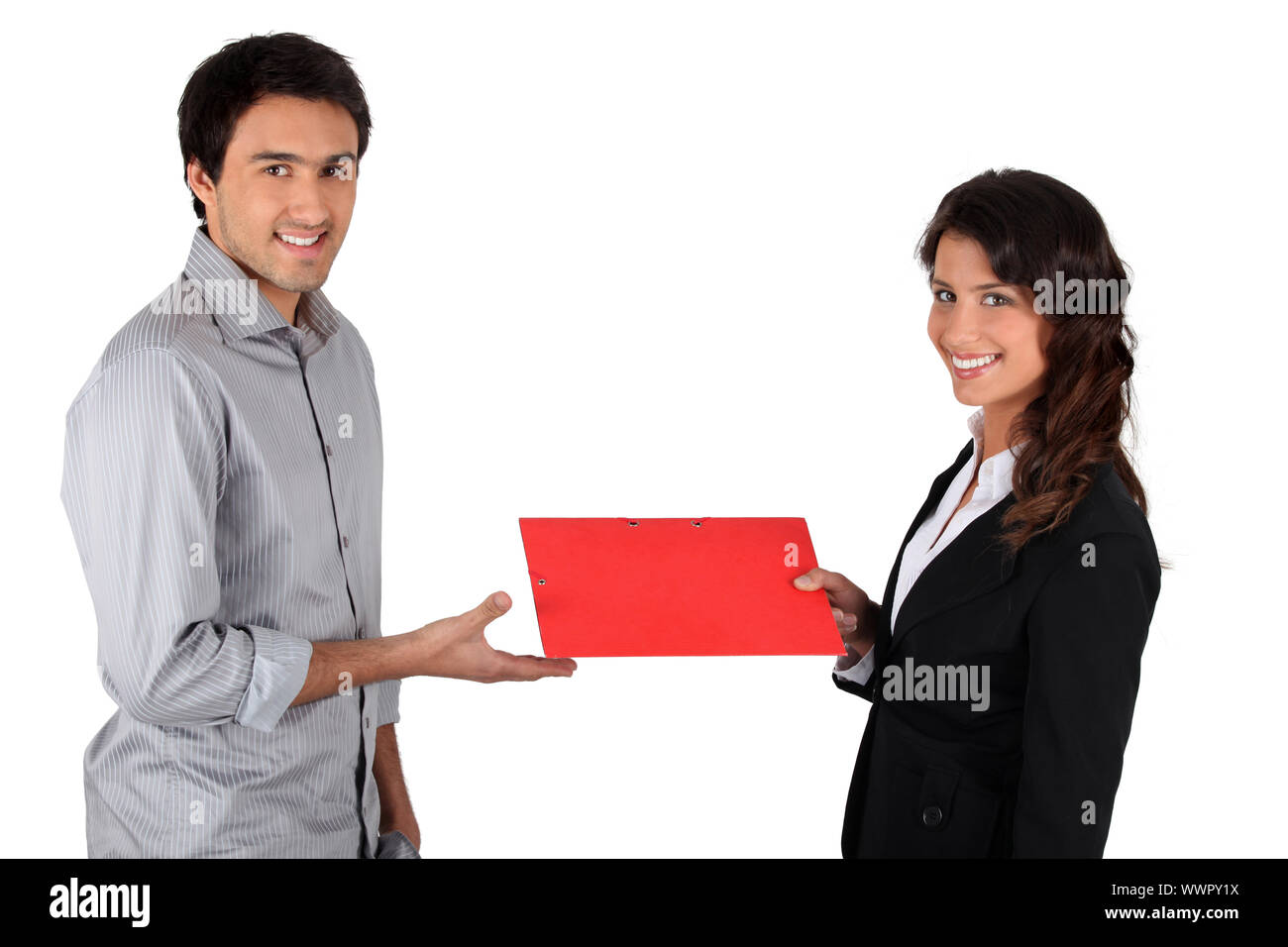 Woman handing folder to man Stock Photo - Alamy