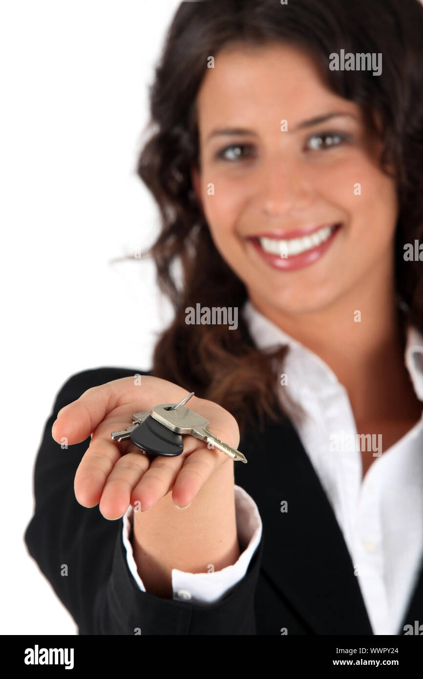 Woman giving keys Stock Photo - Alamy