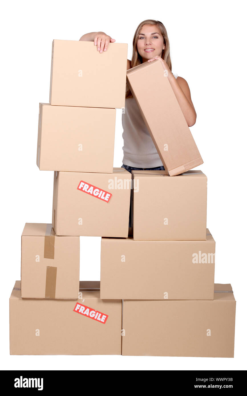 Young woman with a pile of cardboard boxes marked fragile Stock Photo - Alamy
