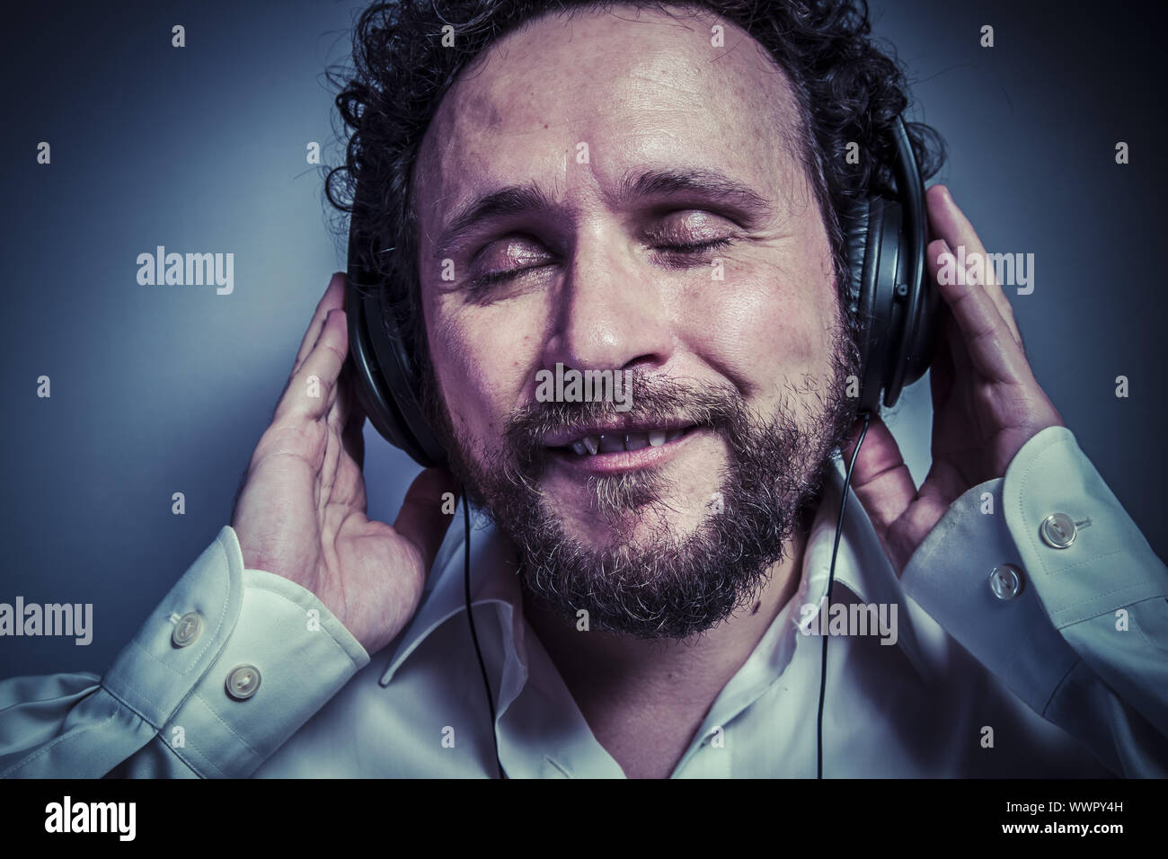enjoy the music, man with intense expression, white shirt Stock Photo ...