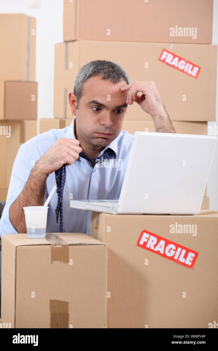 Stressed warehouse worker Stock Photo - Alamy
