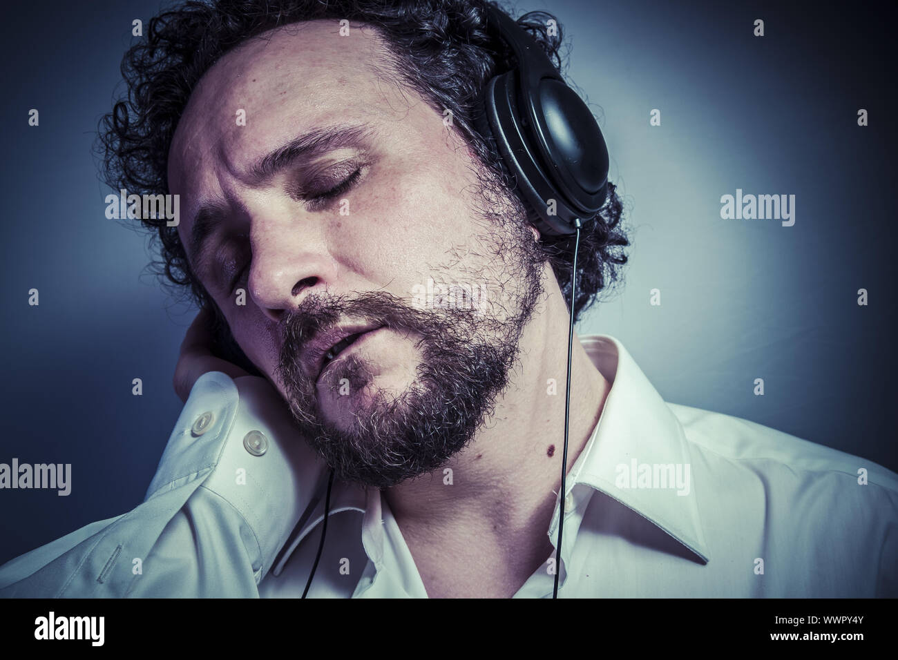 enjoy the music, man with intense expression, white shirt Stock Photo ...
