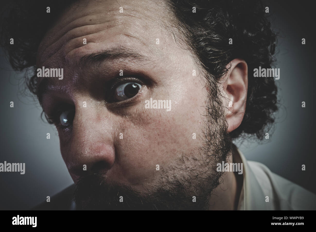 Fear, man with intense expression, white shirt Stock Photo - Alamy