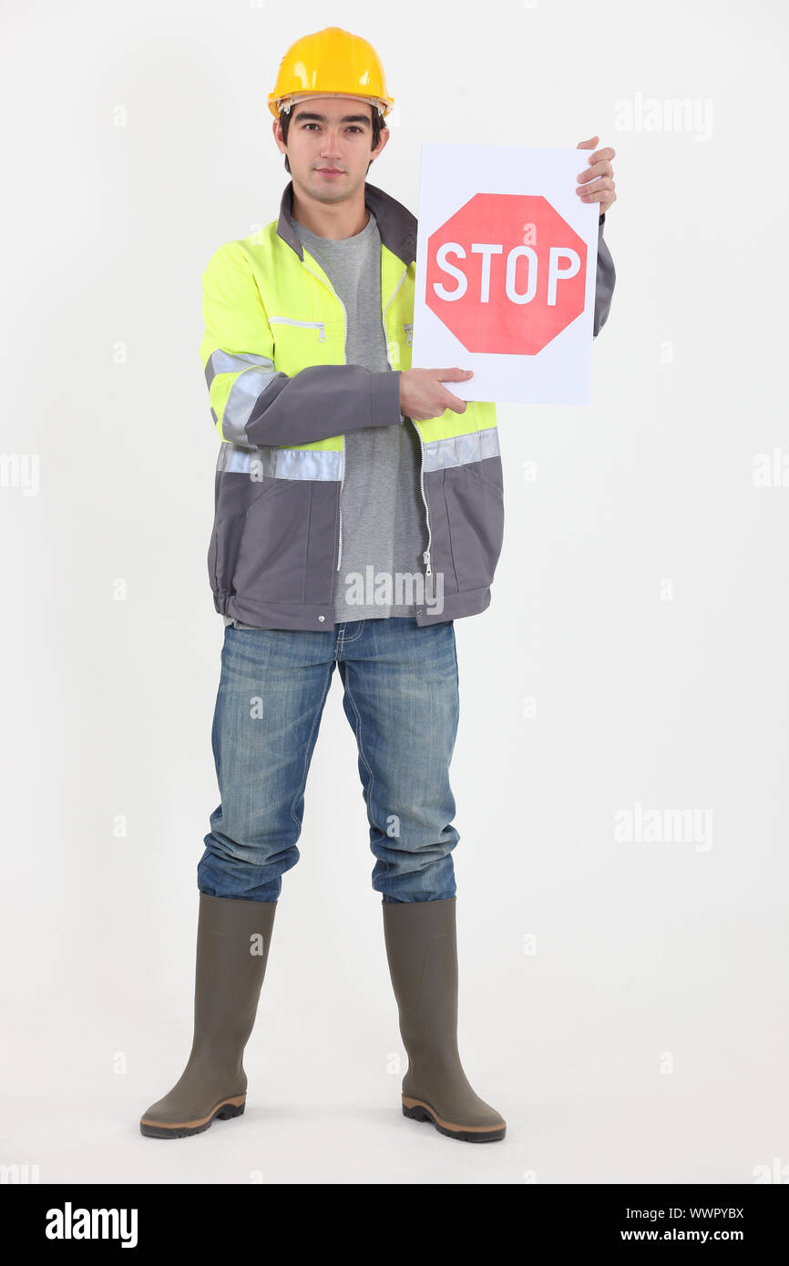 A road worker holding a stop sign Stock Photo - Alamy