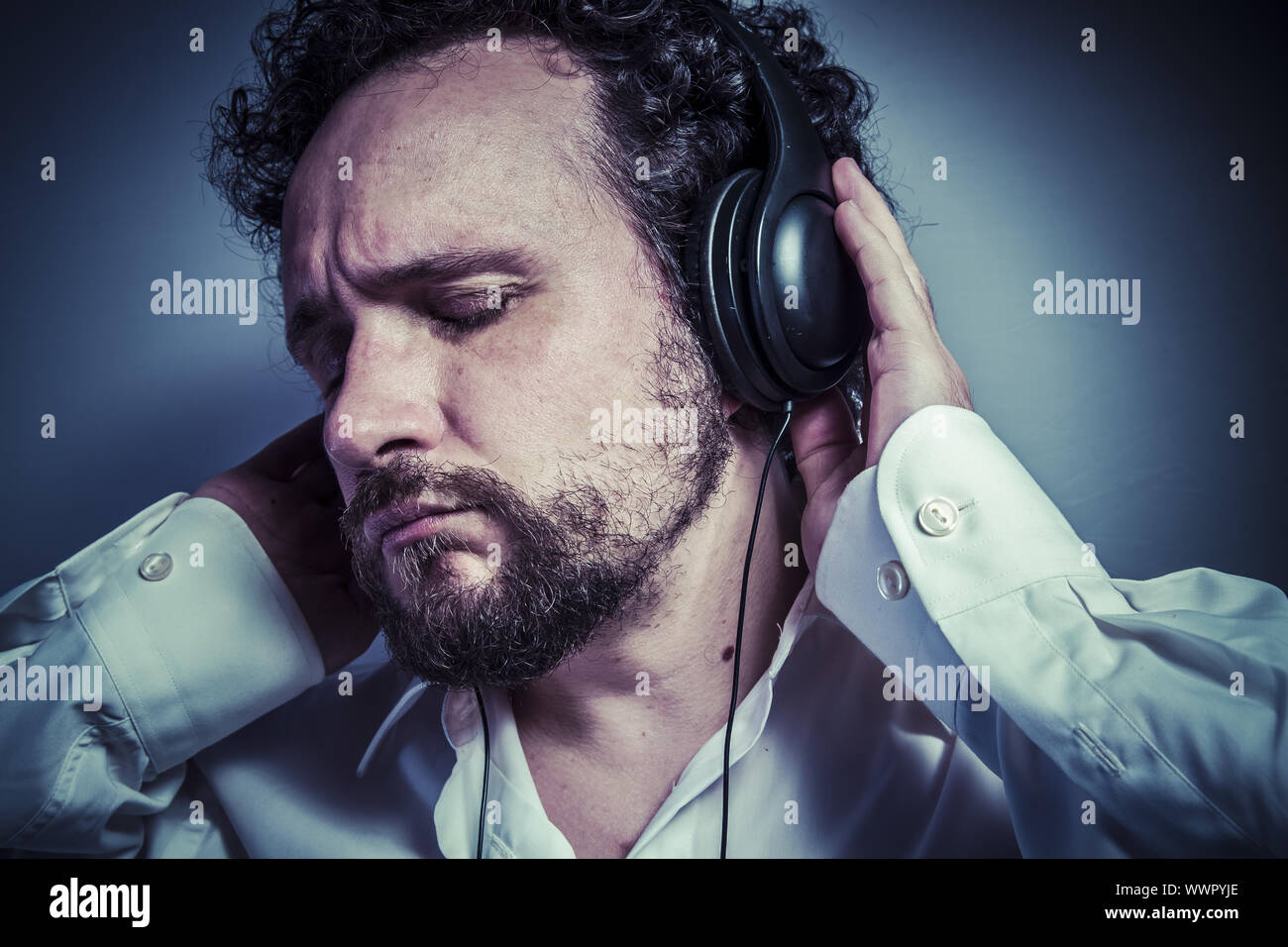 enjoy the music, man with intense expression, white shirt Stock Photo ...