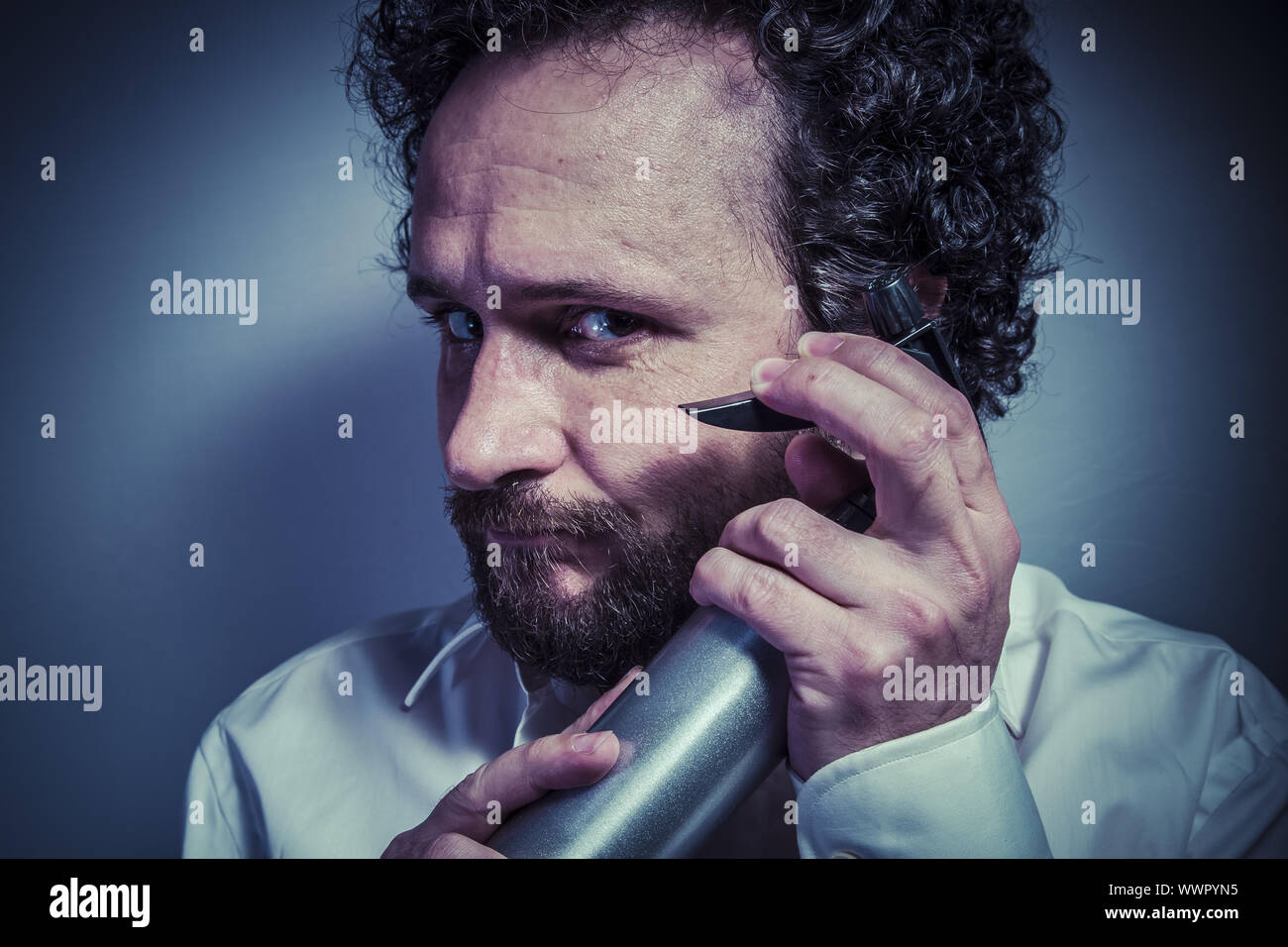 cleaning spray, man with intense expression, white shirt Stock Photo ...