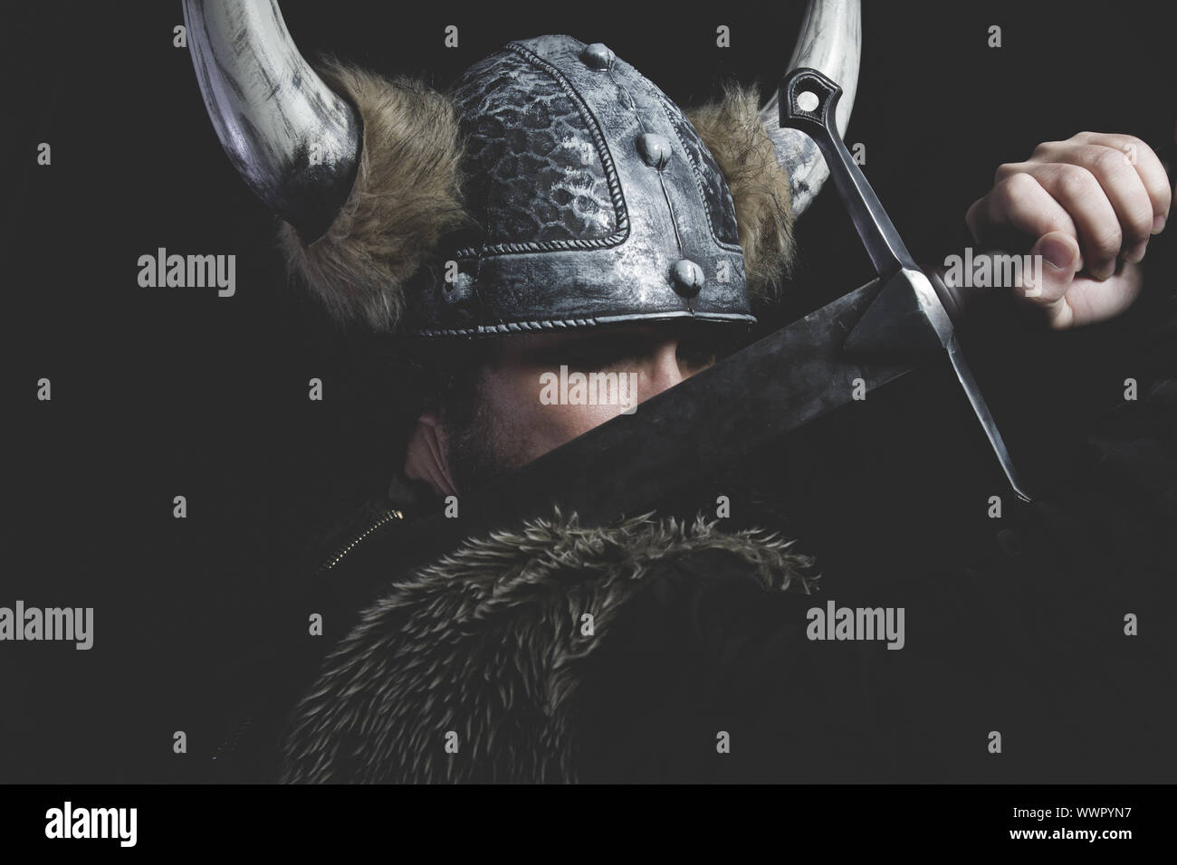 Furious, Viking warrior with iron sword and helmet with horns Stock ...