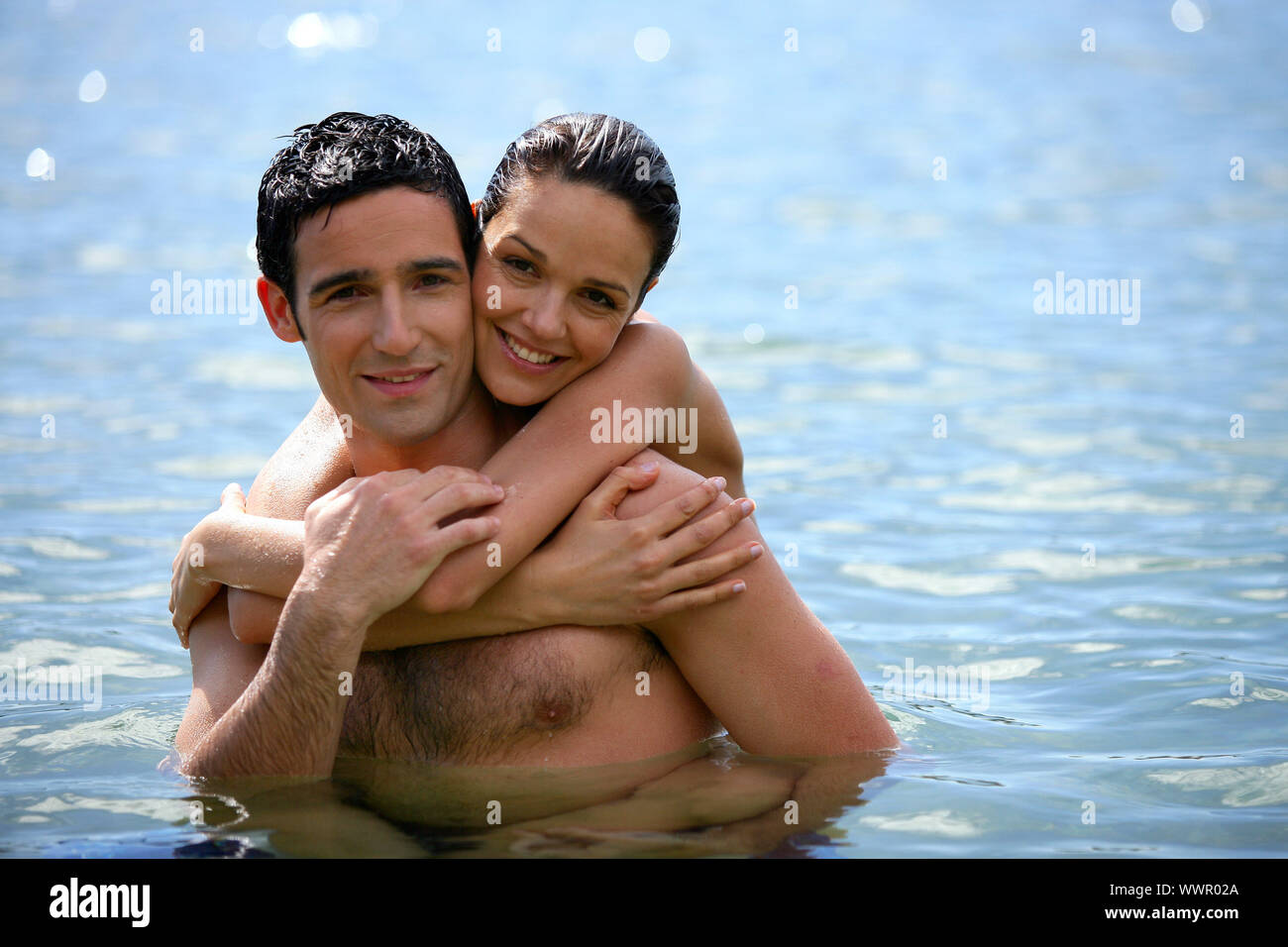 Woman in bikini hugging swimming hi-res stock photography and images ...