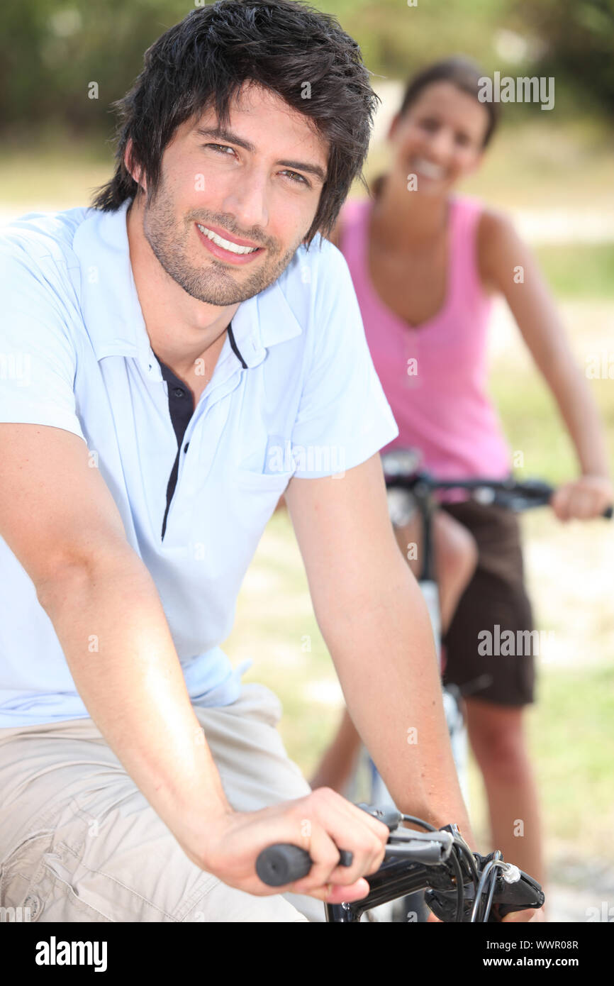 couple riding bicycle Stock Photo - Alamy