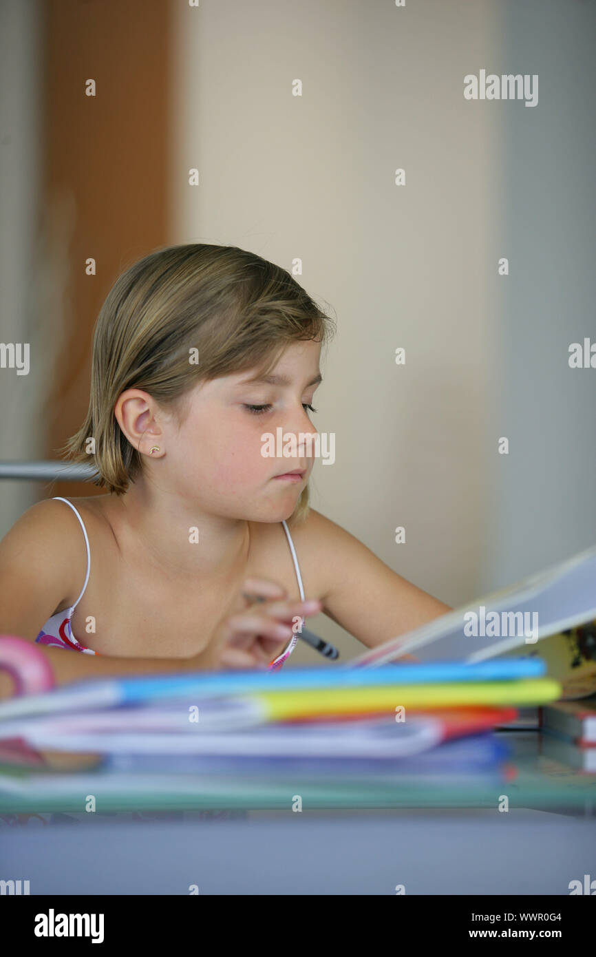 Young girl working on her homework Stock Photo - Alamy