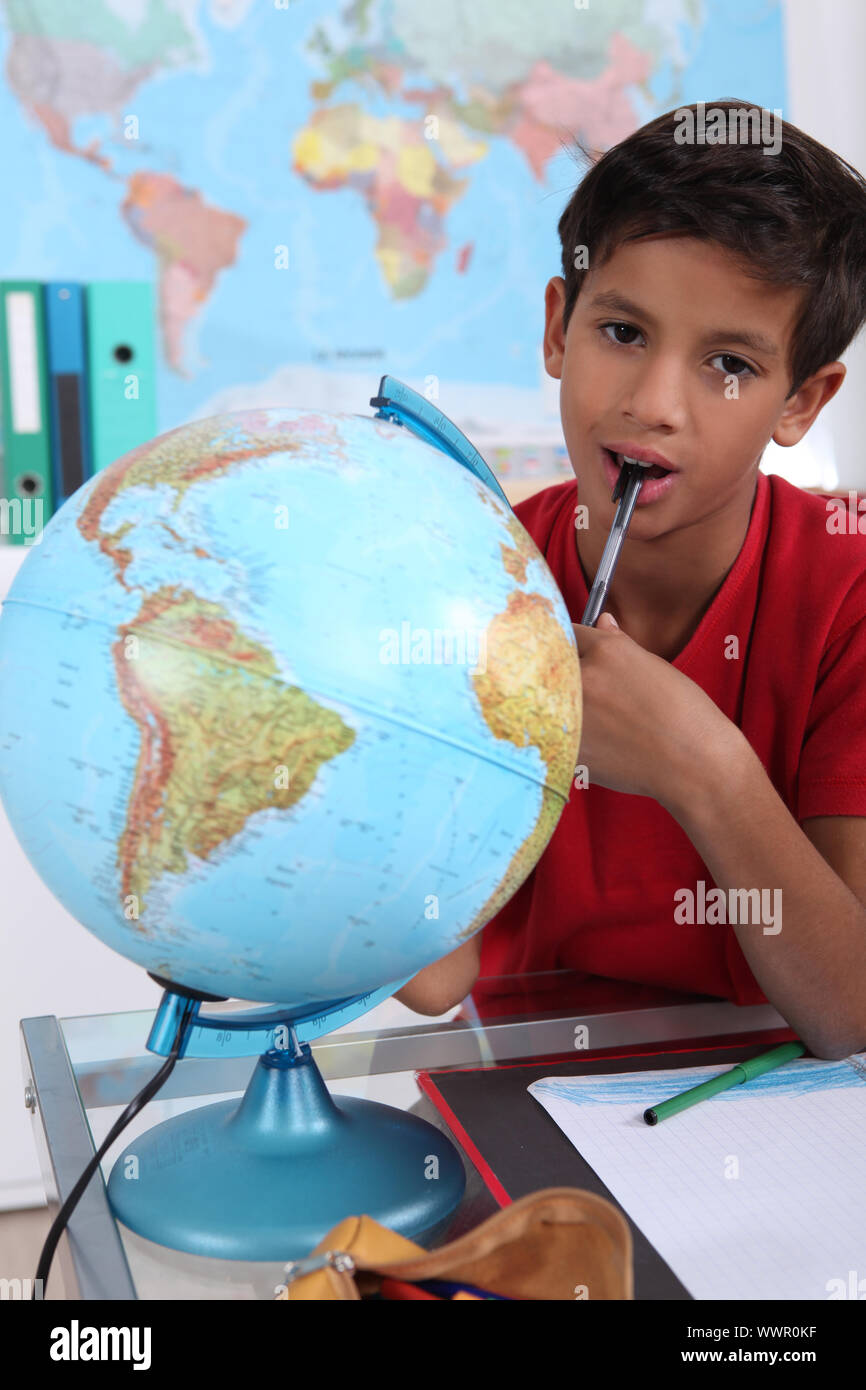 Little boy in classroom, looking bored Stock Photo - Alamy