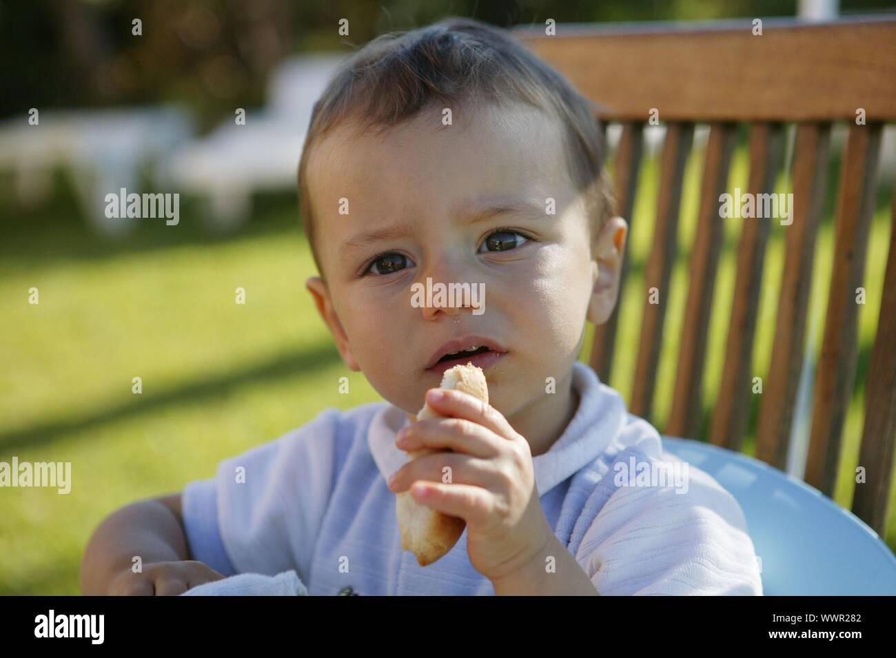 Toddler having a snack Stock Photo - Alamy