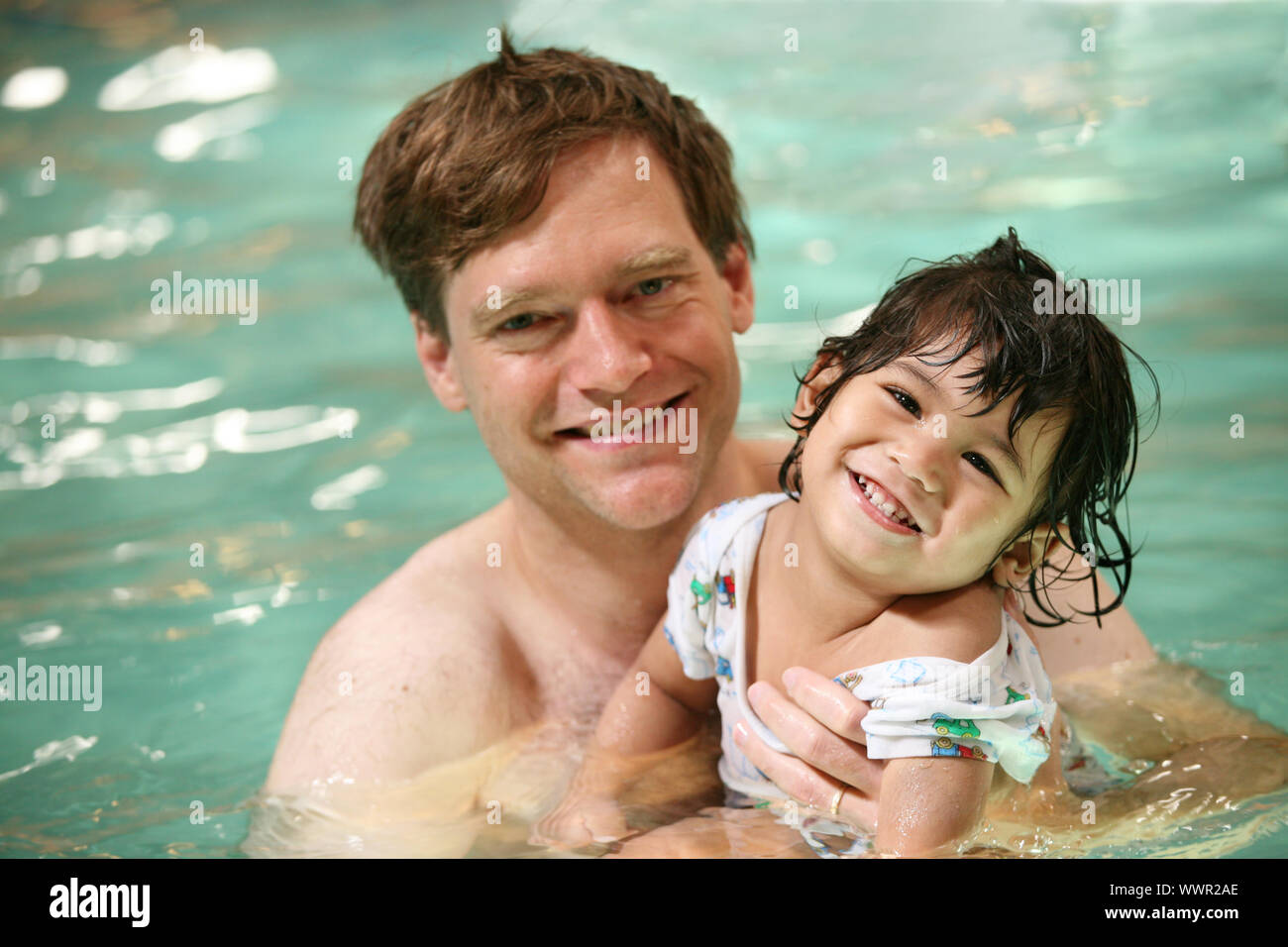 Father and toddler boy swimming in pool Stock Photo - Alamy