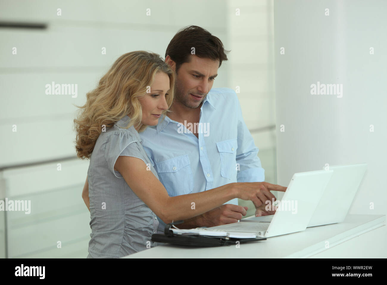 Couple at work on laptops Stock Photo - Alamy