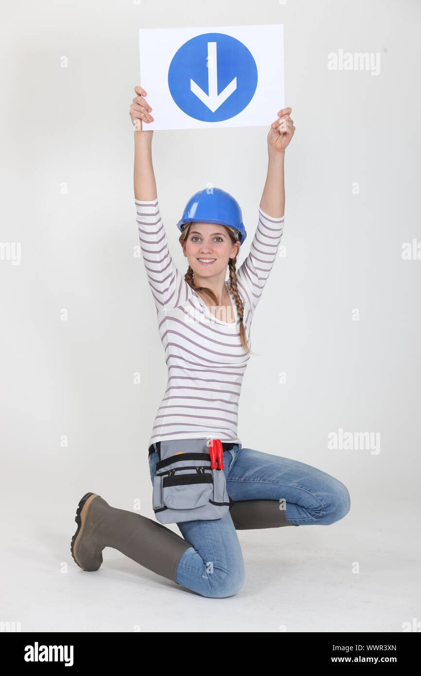 Woman holding road sign Stock Photo - Alamy