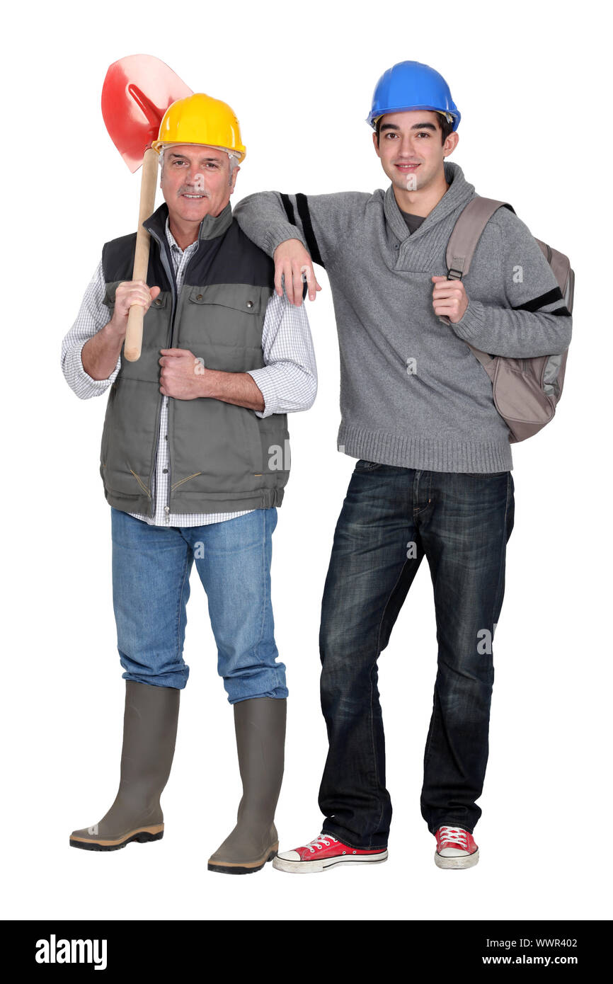 Builder with young apprentice Stock Photo - Alamy