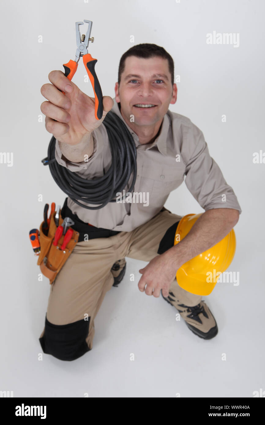 An electrician holding a wire stripper Stock Photo - Alamy