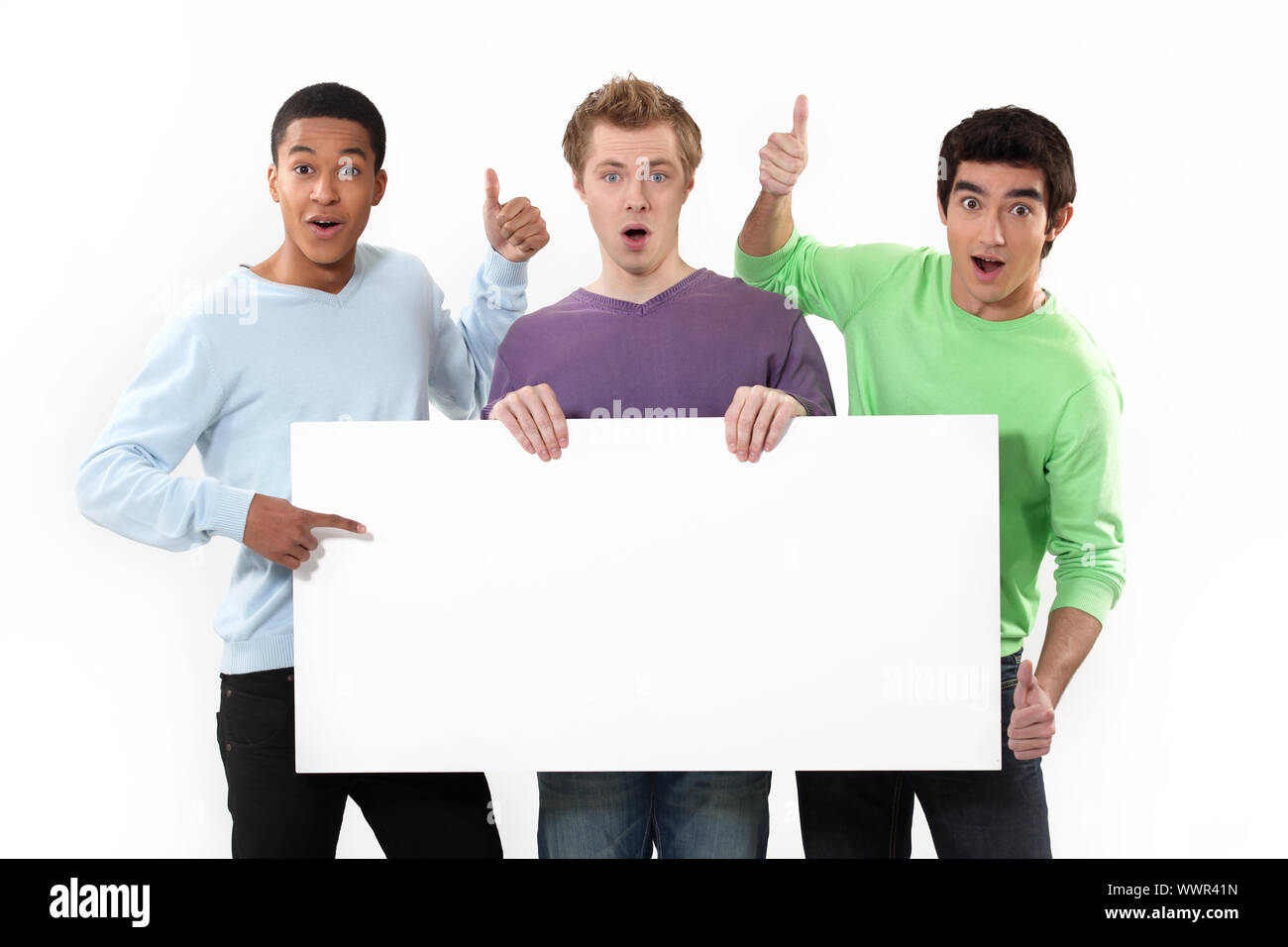 Expressive men holding a white sign for message Stock Photo - Alamy