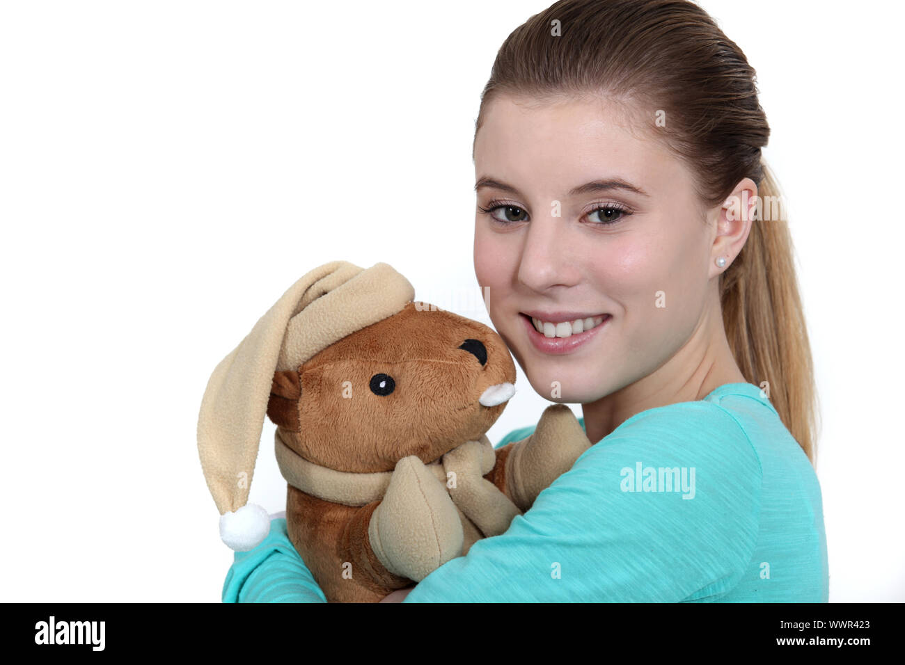 Teenage girl hugging cuddly toy Stock Photo - Alamy