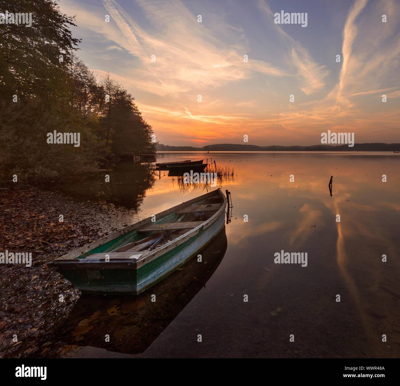 Beautiful lake landscape with fisherman boat and sunset sky. Typical ...