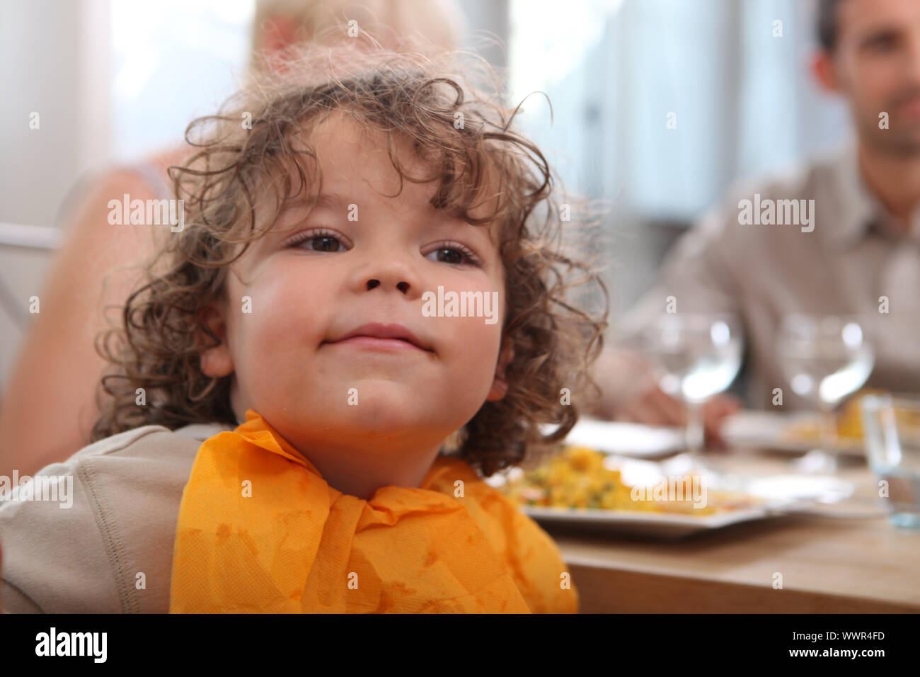 cute toddler having dinner with parents Stock Photo - Alamy