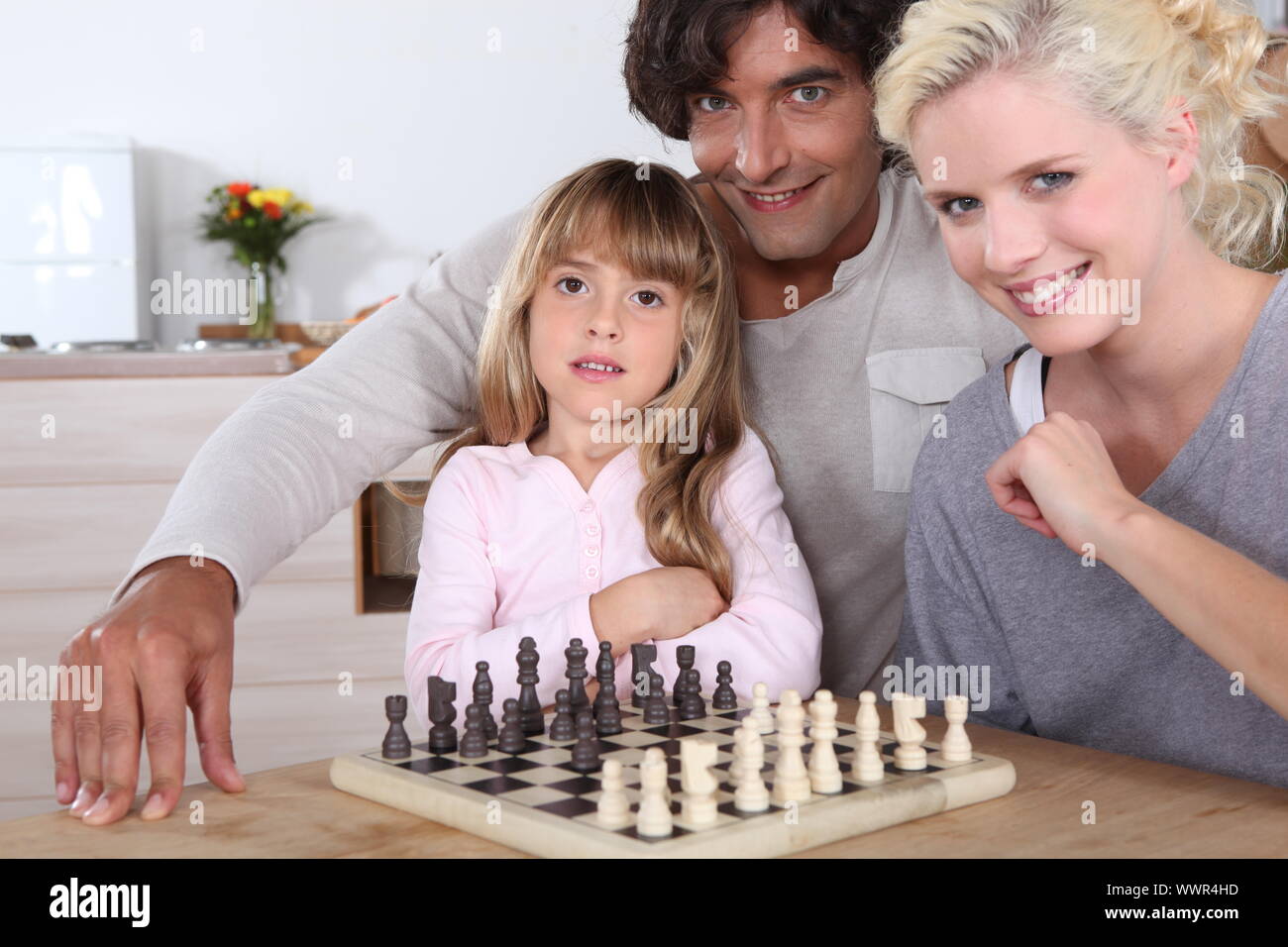 Family playing chess Stock Photo - Alamy