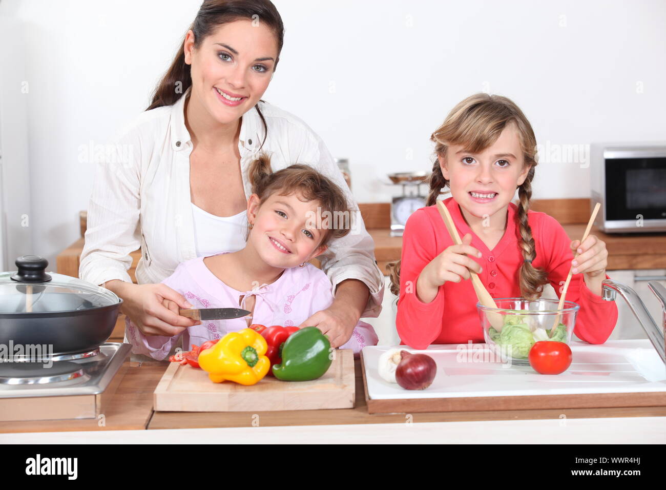 Kids cooking with their mother Stock Photo - Alamy