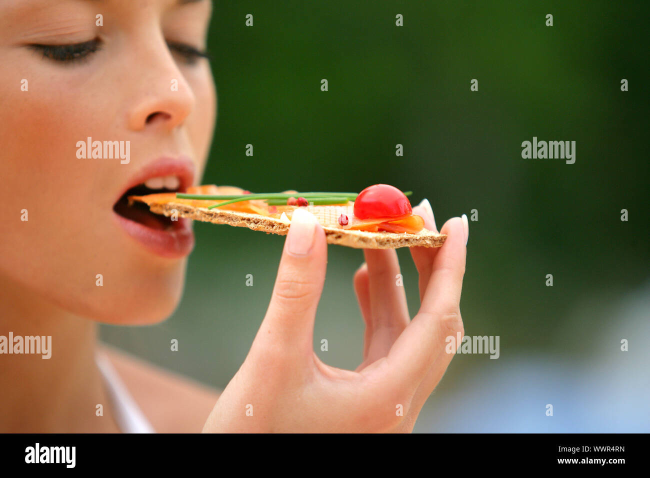 Woman eating healthy cracker snack Stock Photo - Alamy