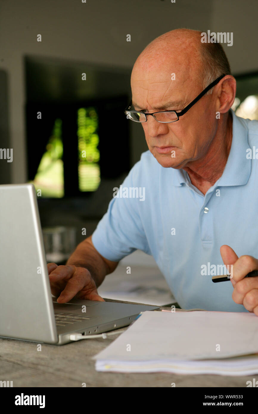 Senior man paying his bills Stock Photo - Alamy