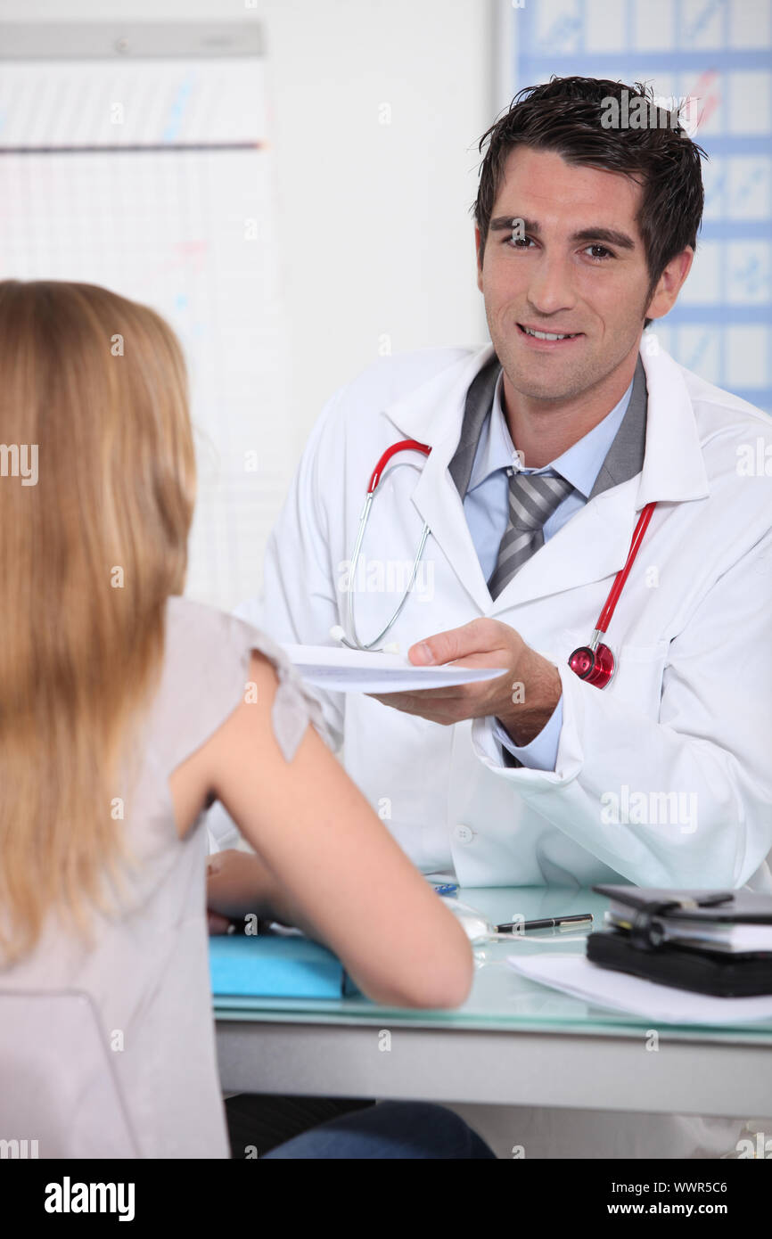 Male doctor with young patient Stock Photo - Alamy