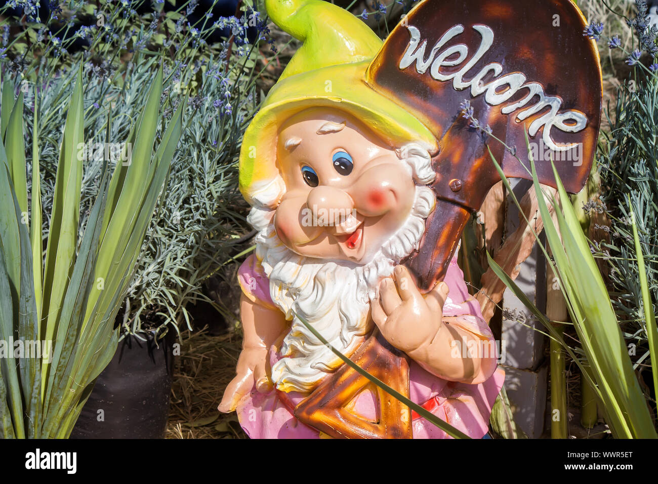 Figure fun funny dwarf in a top hat and with a shovel Stock Photo - Alamy