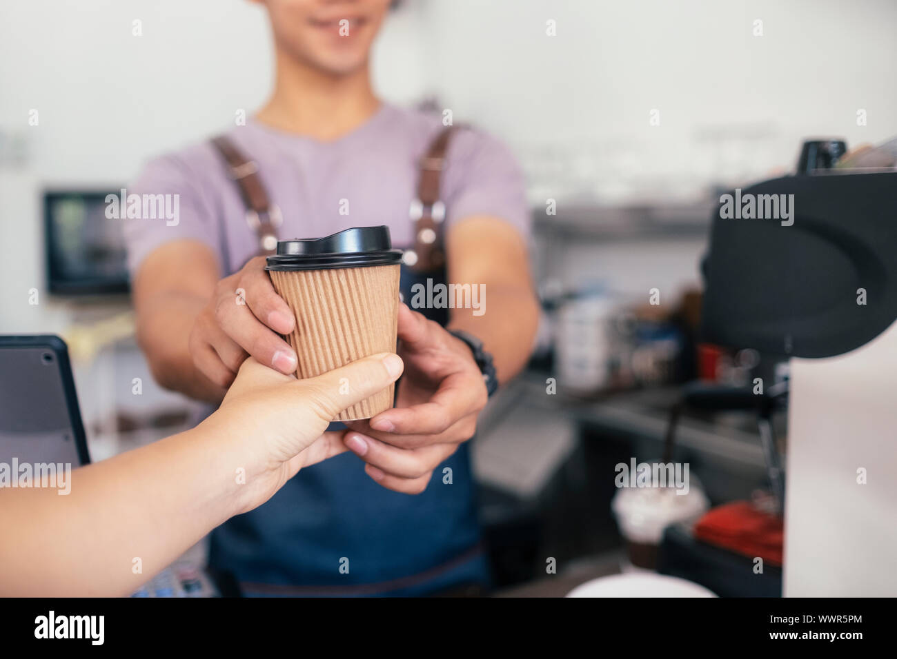 Young owner of coffee cafe service customer. Small business and owner ...