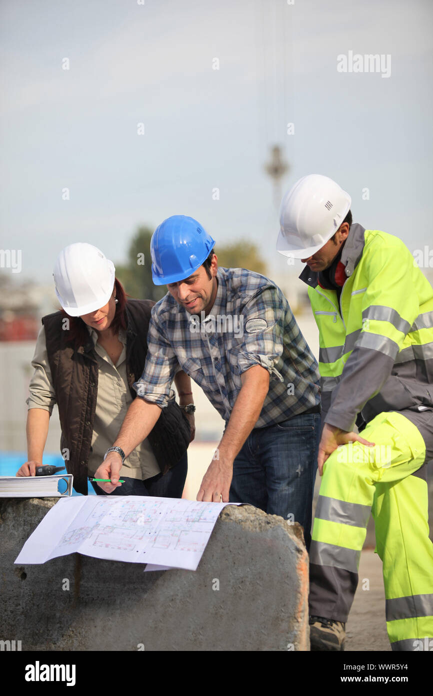 Construction workers looking at site plans Stock Photo - Alamy