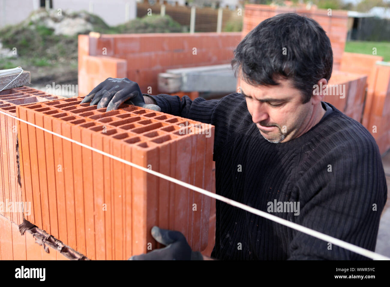 Mason laying bricks Stock Photo - Alamy
