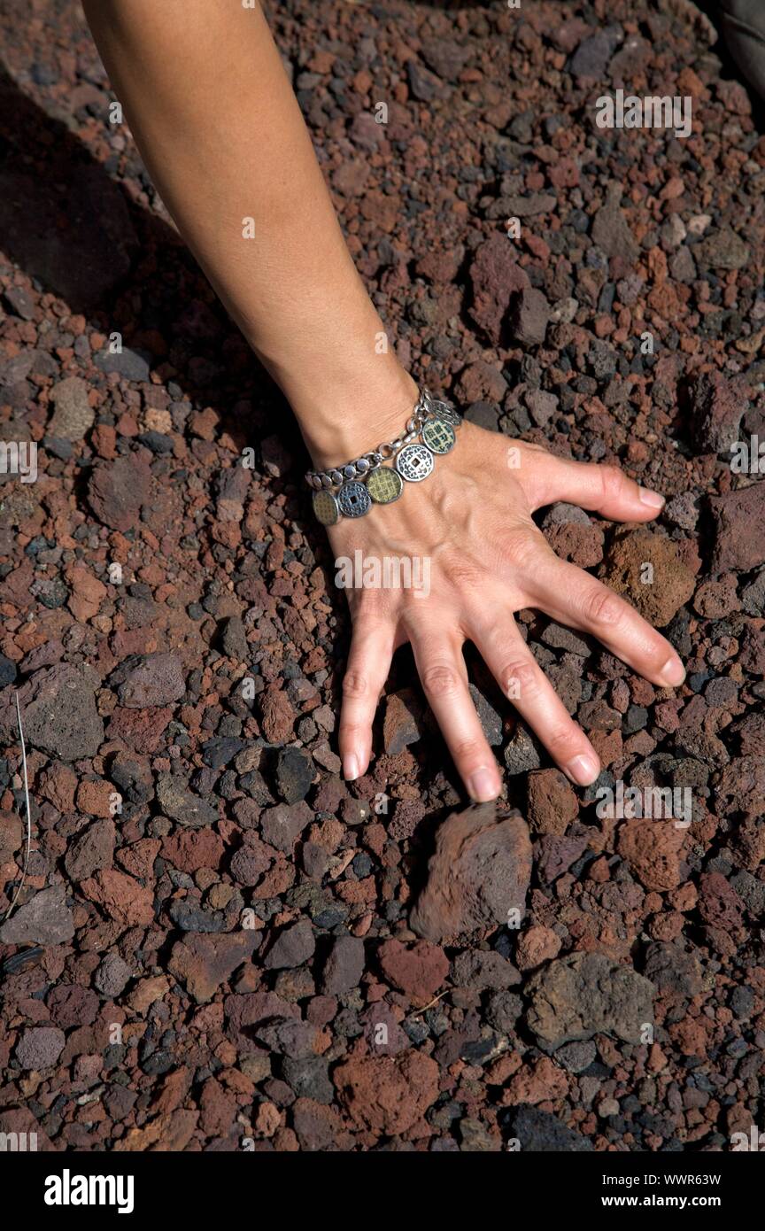 woman hand on volcanic stones Stock Photo - Alamy