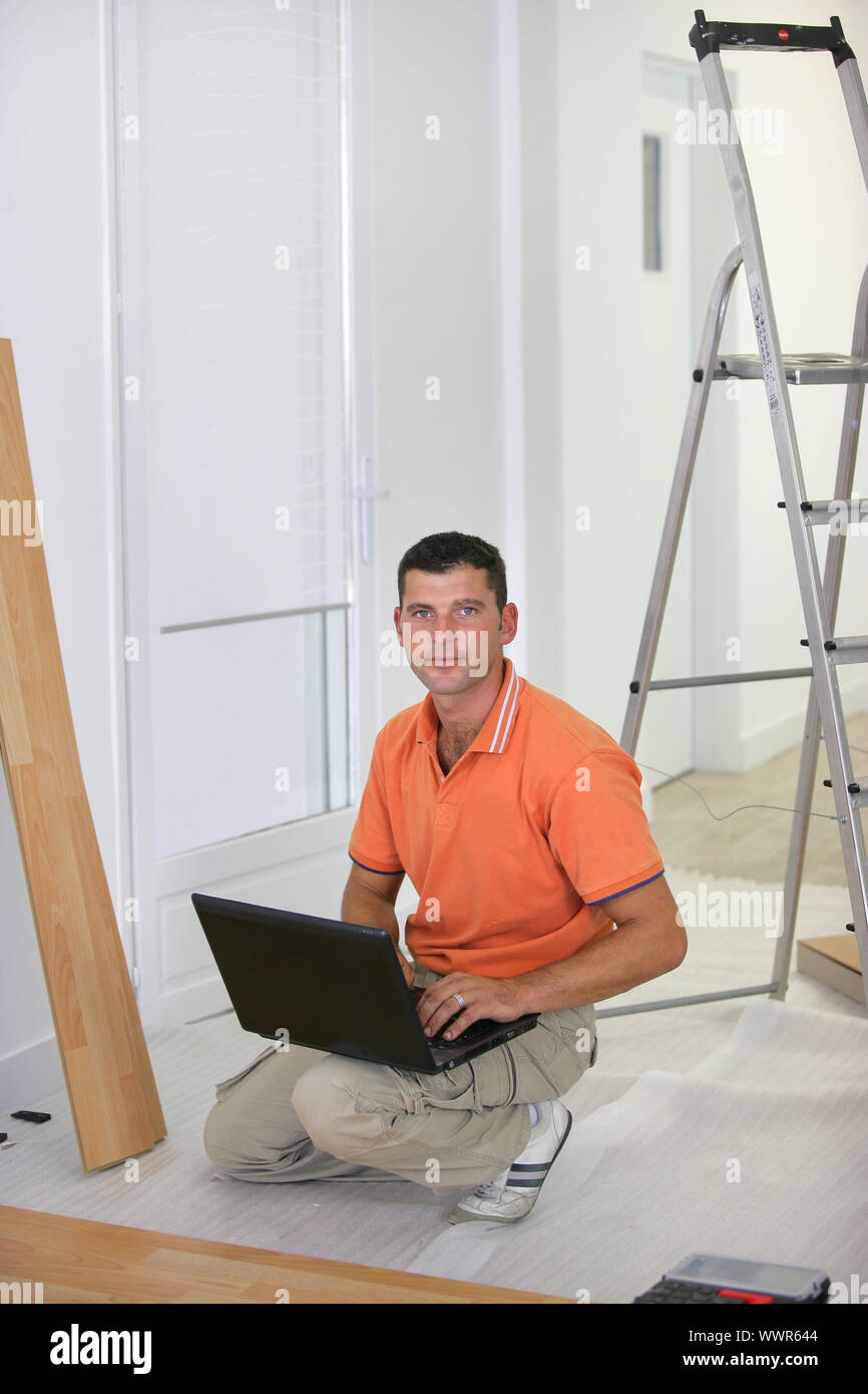 Floorlayer with a laptop computer Stock Photo - Alamy