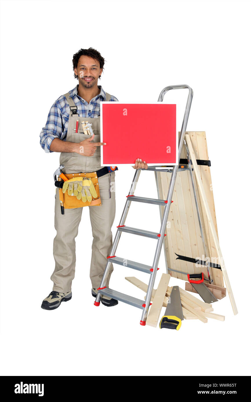 carpenter holding red sign Stock Photo - Alamy