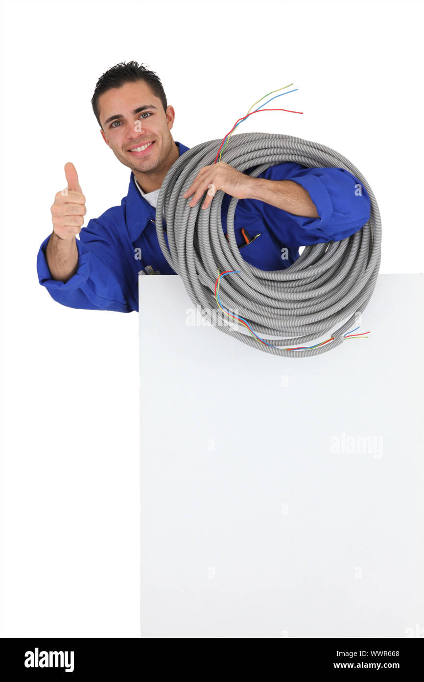 Electrician with long cable giving the thumbs-up Stock Photo - Alamy