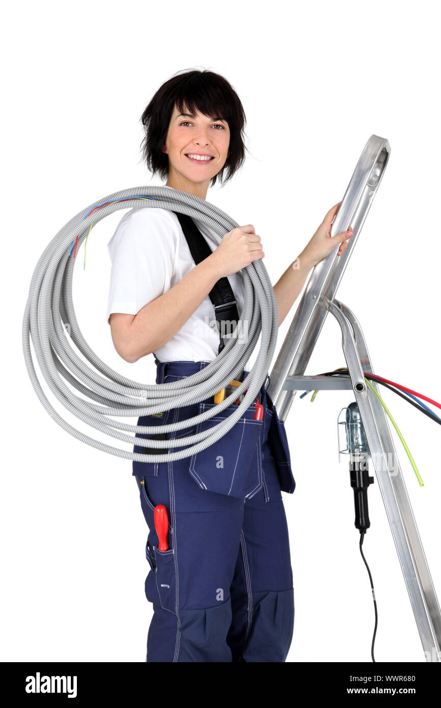 Female laborer standing next to a ladder Stock Photo - Alamy