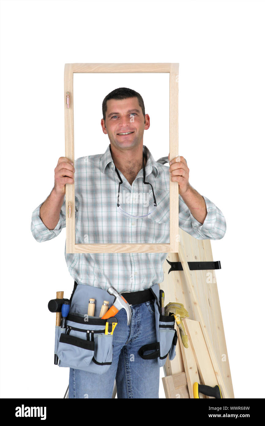 Carpenter showing wood frame Stock Photo - Alamy