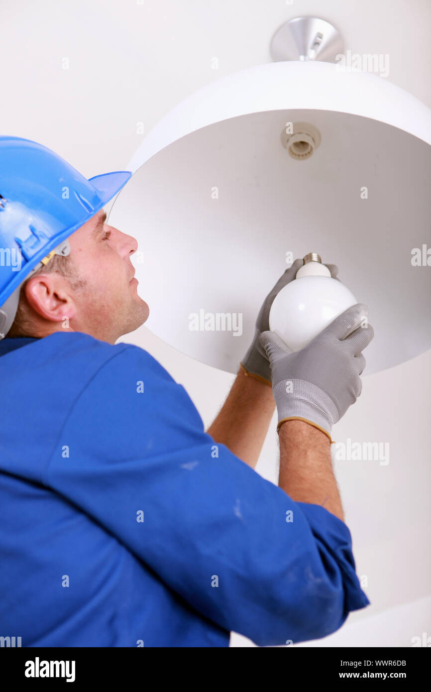 Fixing light fitting woman hi-res stock photography and images - Alamy