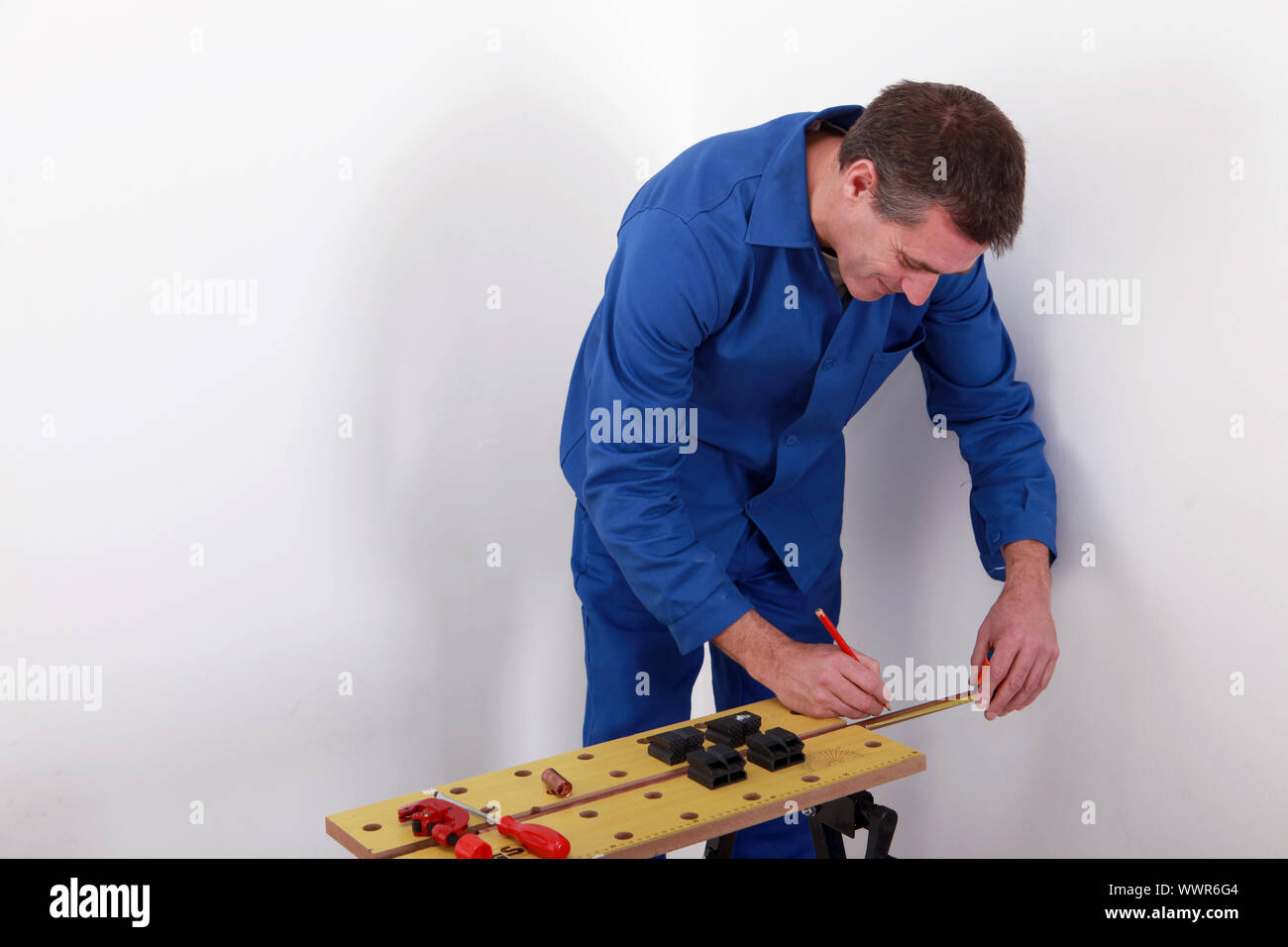 Plumber measuring copper pipe Stock Photo - Alamy