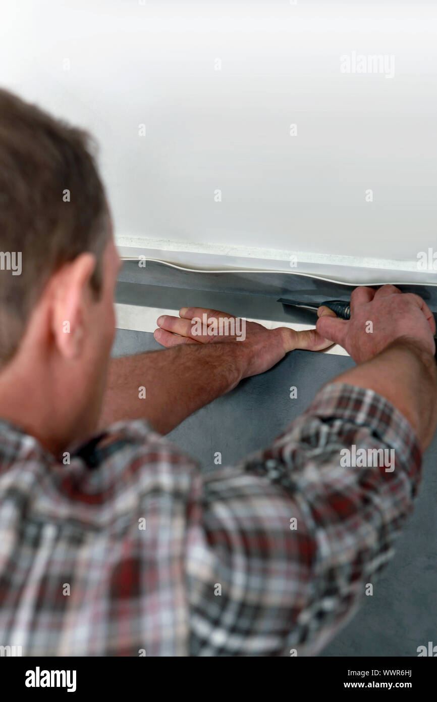 A man laying carpet Stock Photo - Alamy