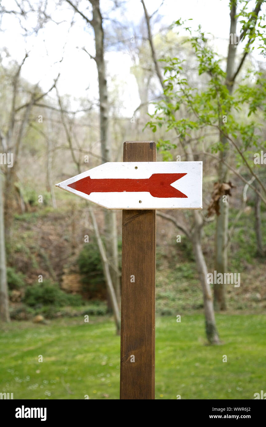 direction sign with an arrow at a spanish path Stock Photo - Alamy