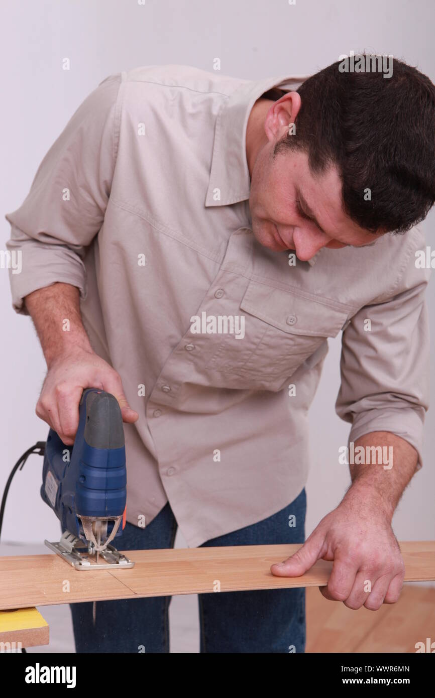 Man using an electric jigsaw Stock Photo - Alamy