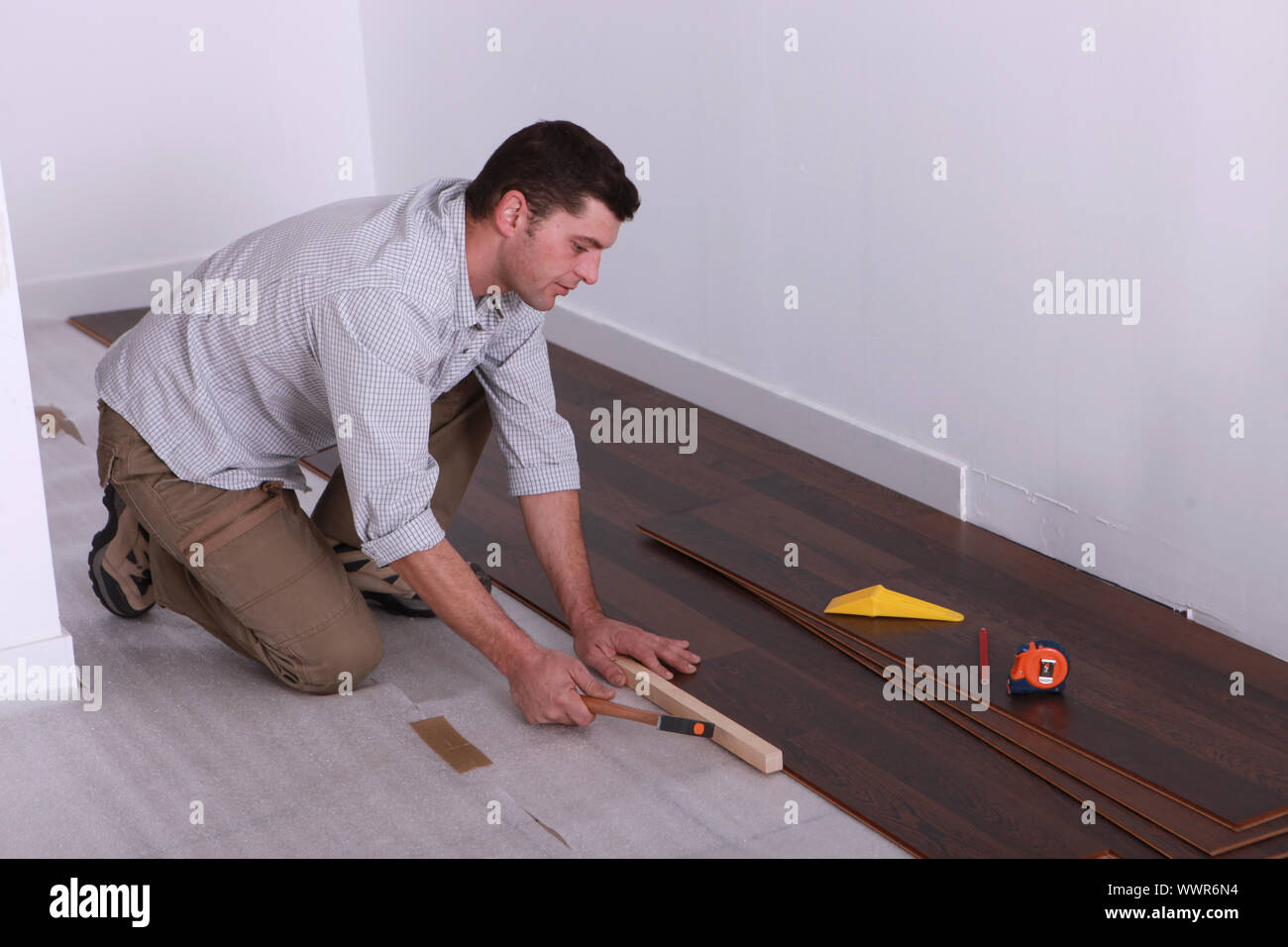 craftsman putting a wood flooring Stock Photo - Alamy