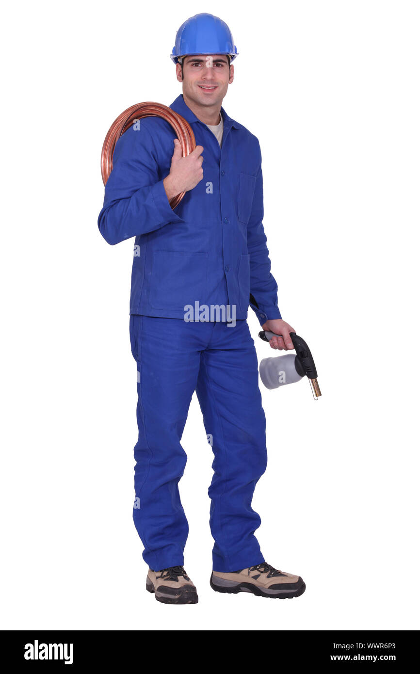 Man holding copper piping and blowtorch Stock Photo - Alamy