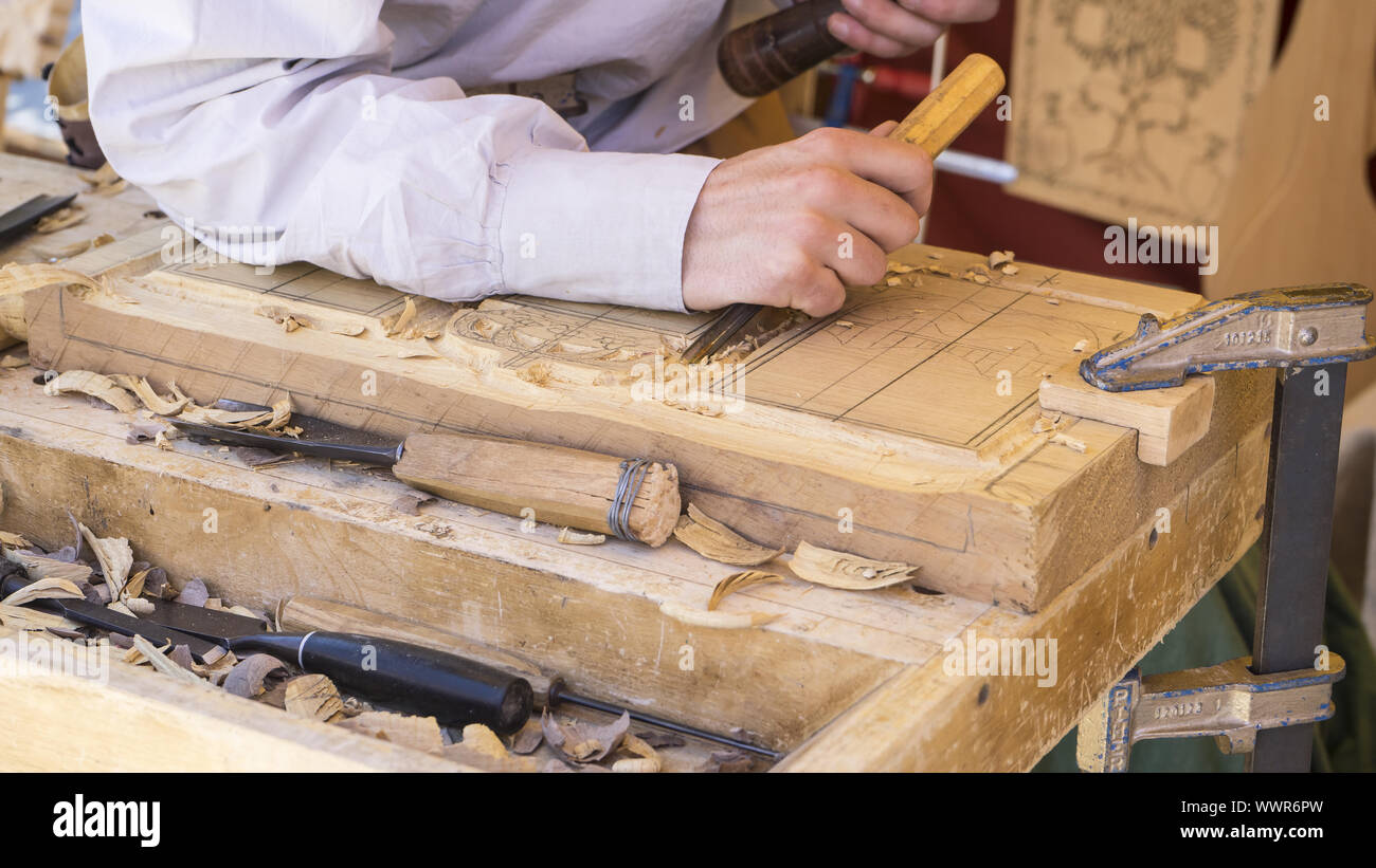 craftsman carving wood in a medieval fair, carpentry tools Stock Photo ...