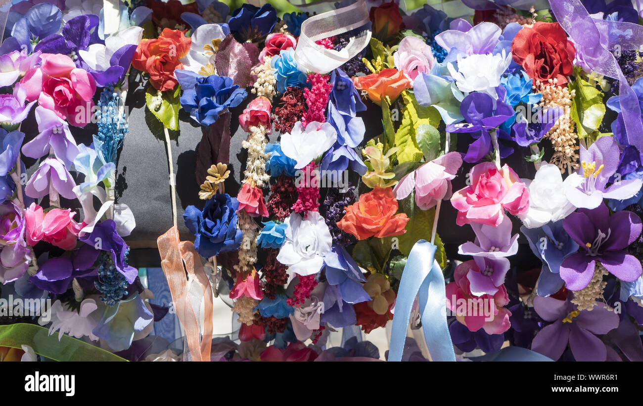 garlands of flowers in a traditional medieval crafts fair in Spain ...